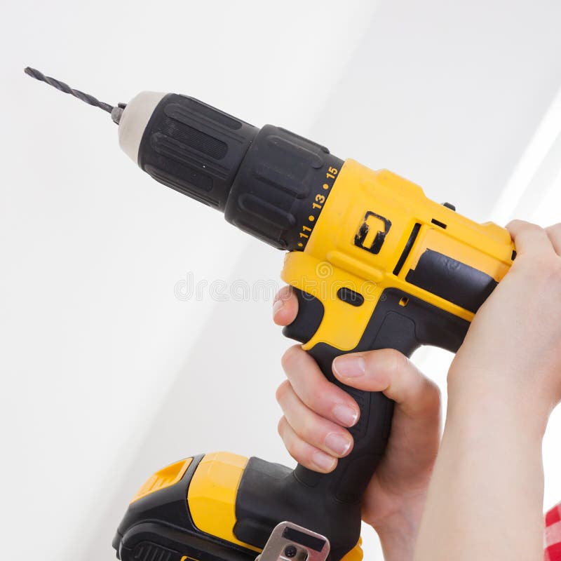 Hand holding yellow drill stock photo. Image of hand - 172506370