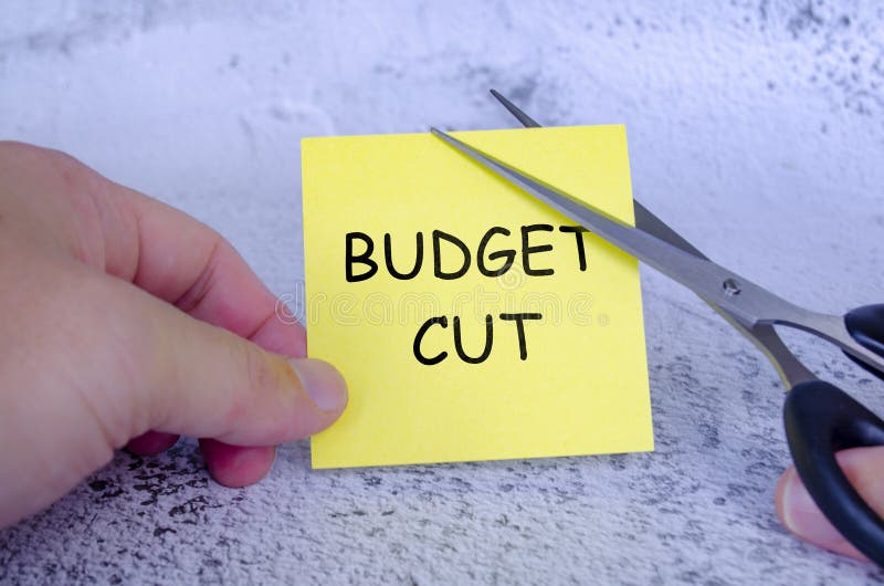 Hand Holding a Yellow Sticky Note with the Words Budget Cut Written on ...