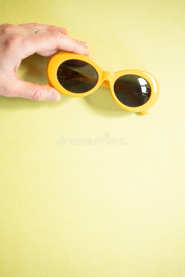 Hand Holding Yellow Sunglasses on Yellow Stock Image - Image of ...