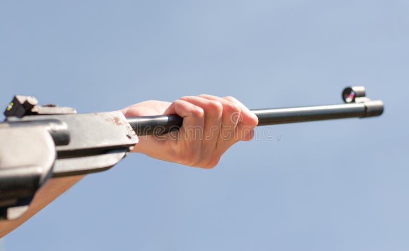 Hand Holds the Barrel of an Air Rifle Against a Blue Sky Stock Image ...