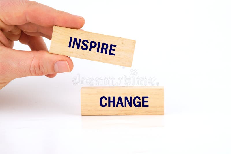 A Hand Holds a Block Labeled Inspire while Another Block Labeled Change ...