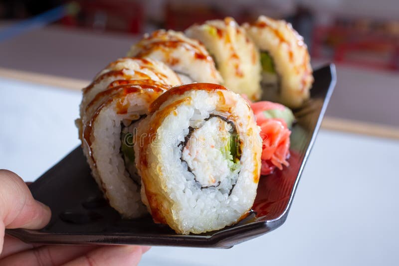 Hand Holds California Roll Plate Stock Image - Image of food, copy ...