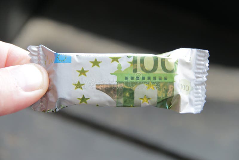 A Hand Holds a Candy with a Wrapper in the Form of a One Hundred Euro ...