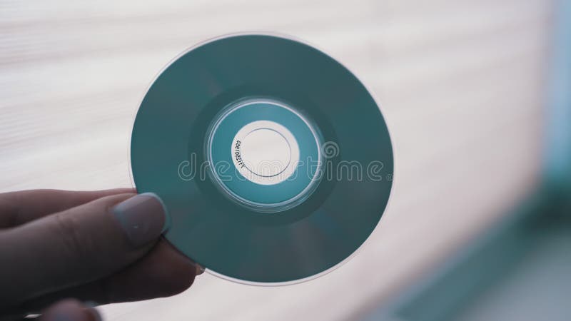 Hand Holding CD-ROM on Blurred Background Stock Video - Video of ...