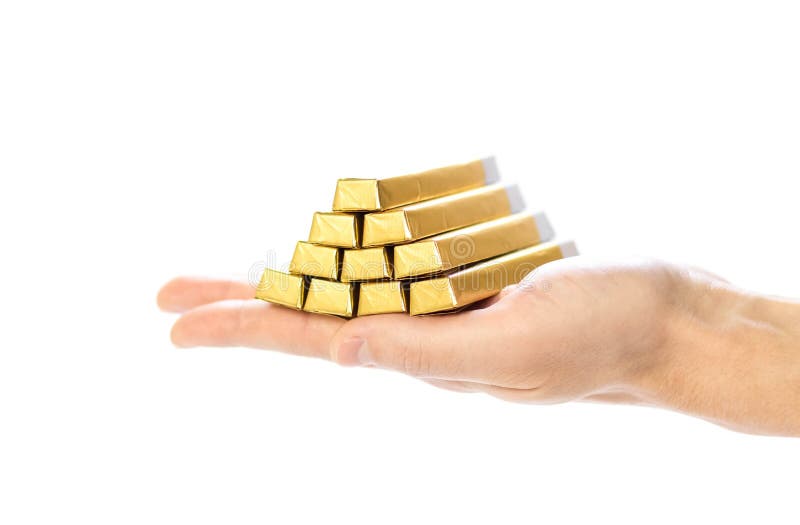 The Hand Holds Chocolate Bars in the Shape of Gold Bars. Close Up Stock ...