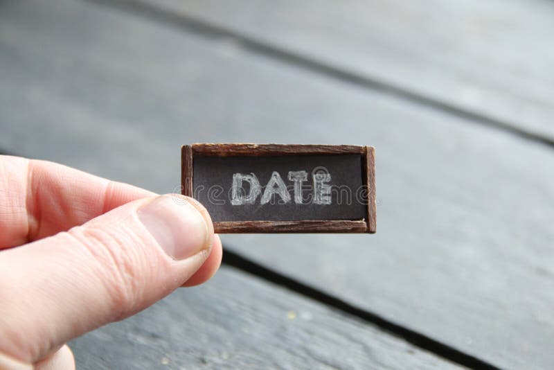 Hand holds a date sign, stock photo. Image of date, idea - 175099114