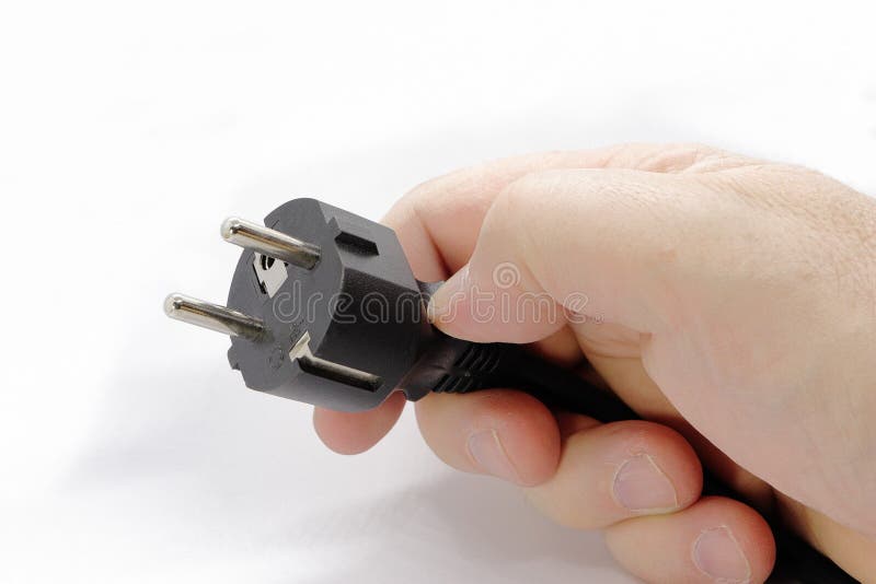 A Hand Holds an Electric Plug. Power Supply Cable Stock Photo - Image ...