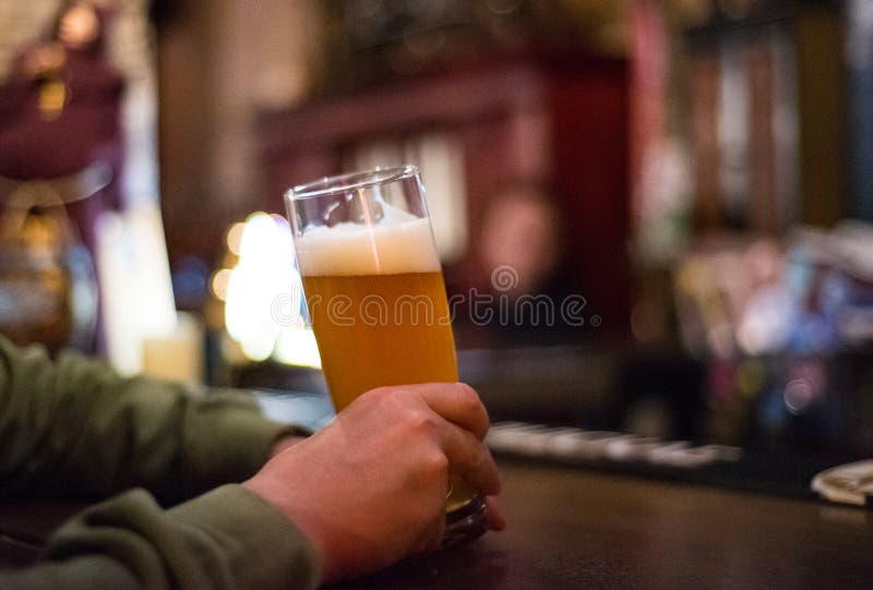 Man`s Hand Holds A Glass Of Amber Pale Ale Beer Stock Image Image Of