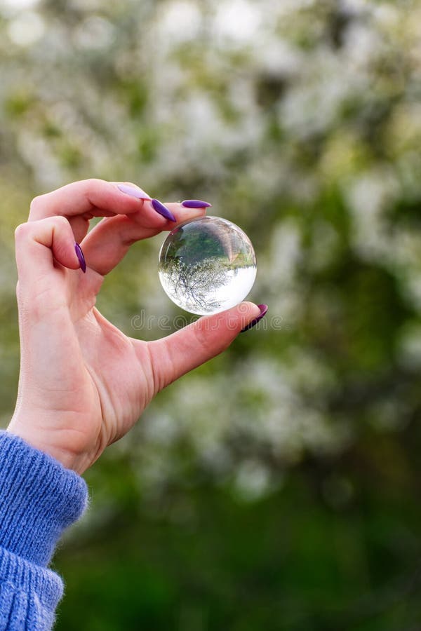 A Hand Holds a Glass Layer. Which Turns the World Upside Down Stock ...