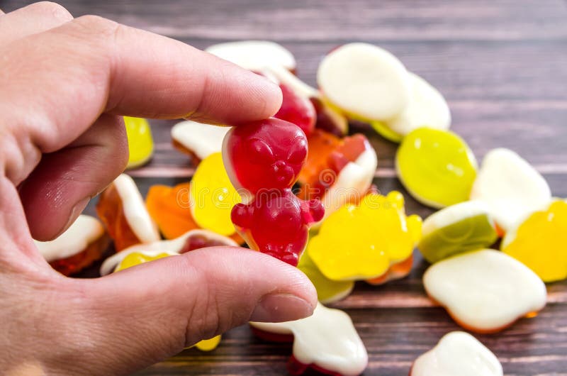 Hand Holds Jelly Candy with Fingers. Close-up. Stock Photo - Image of ...