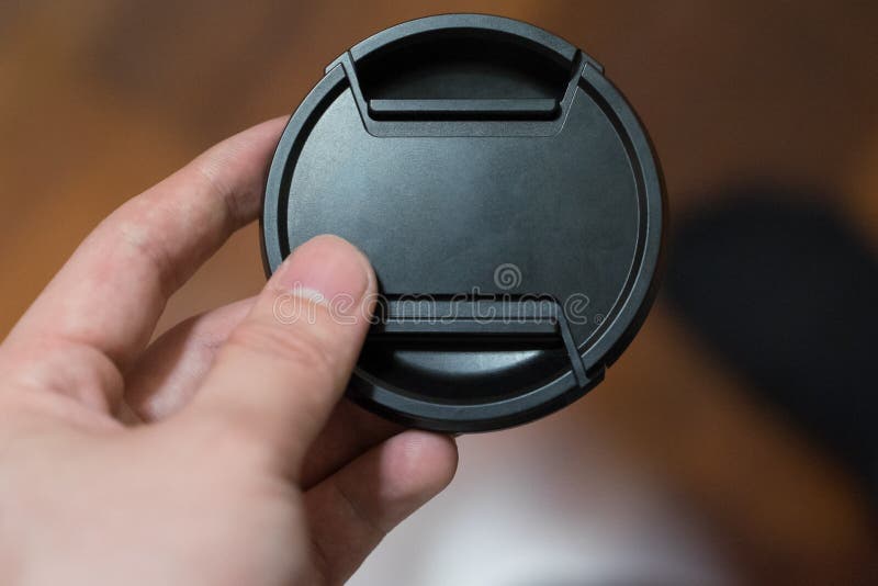 Hand holds Lens cap stock photo. Image of holds, studio - 65646288