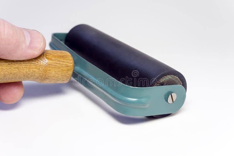 The Hand Holds a Mechanical Rolling Device with a Rubber Roller Stock ...
