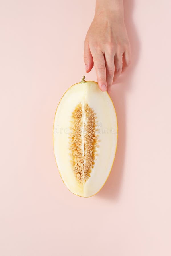 A Hand Holds a Melon on a Light Pink Background Stock Photo - Image of ...