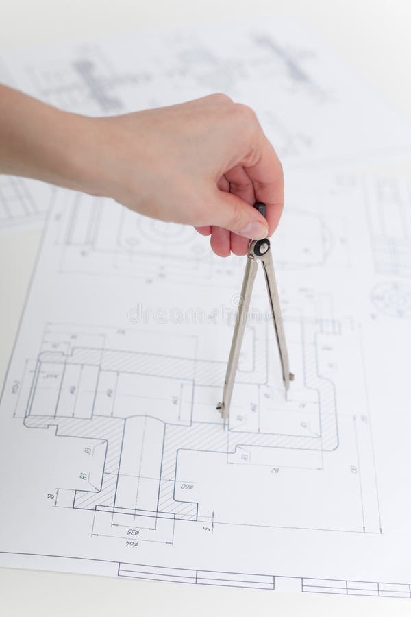 Hand Holds Metal Compasses Against Drawings Stock Photo - Image of ...