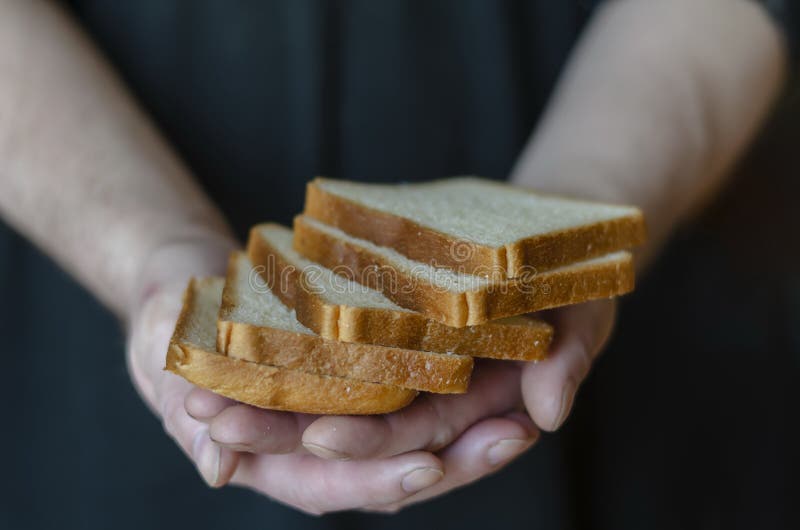 A Hand Holds Out Pieces of Bread into the Camera Stock Image - Image of ...