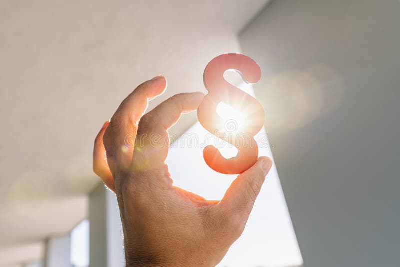 Hand Holds Paragraph Symbol in the Sun at a Office Building Stock Image ...
