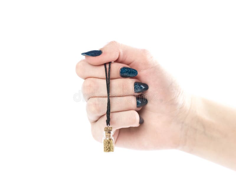 The Hand Holds the Pendant in the Form of a Small Jar. Close Up Stock ...