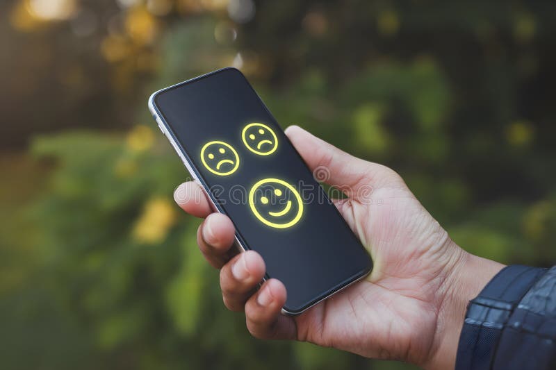 Hand Holds Phone with Sad, Smiling Emoticons Smiling Face Highlighted ...