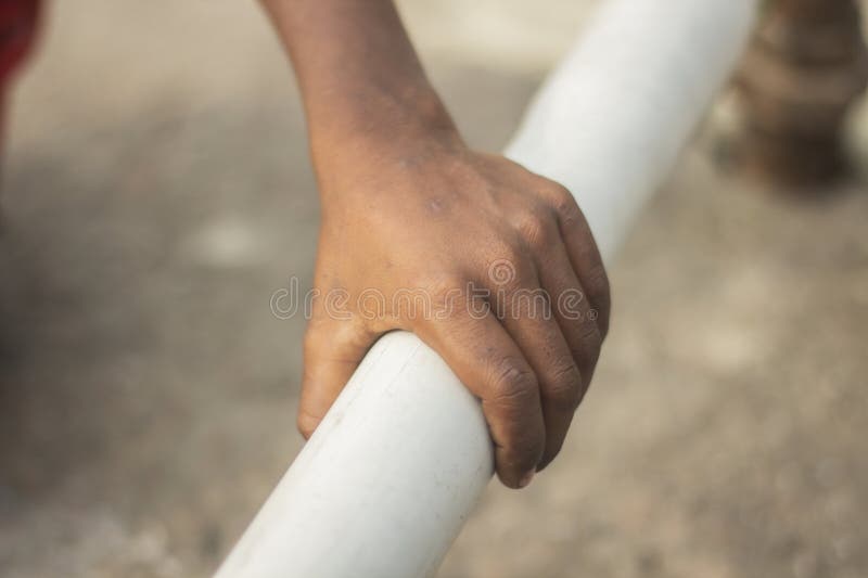 A Hand Holds a Pipe and the Background is Blurred Stock Image - Image ...
