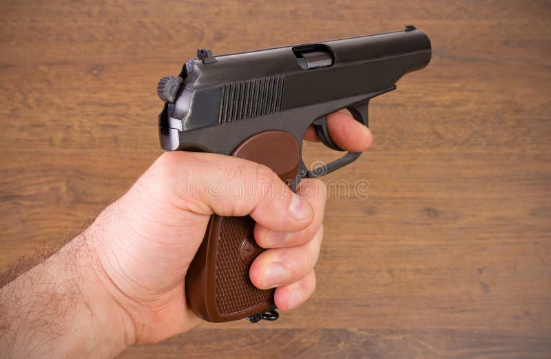 Hand holds a pistol stock photo. Image of horizontal - 26268010