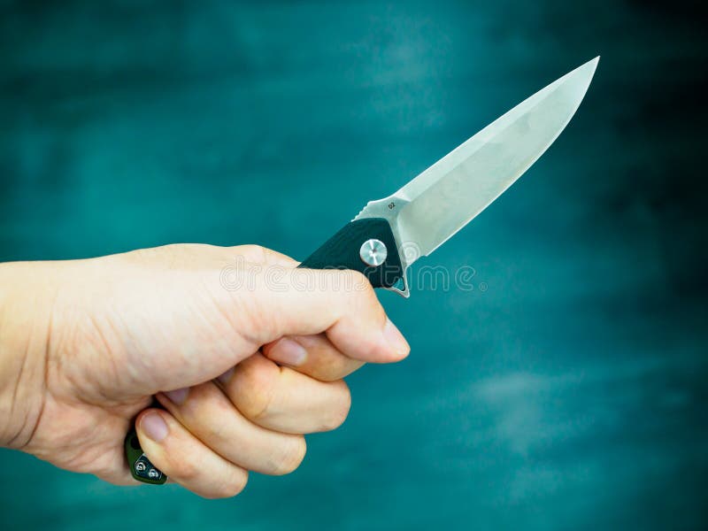 Hand Holding a Pocket-knife Ion Dark Background Stock Photo - Image of ...