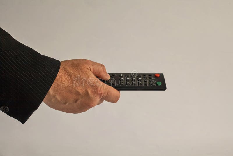 Hand Holds the Remote Control from the TV. Hand Finger Presses the ...