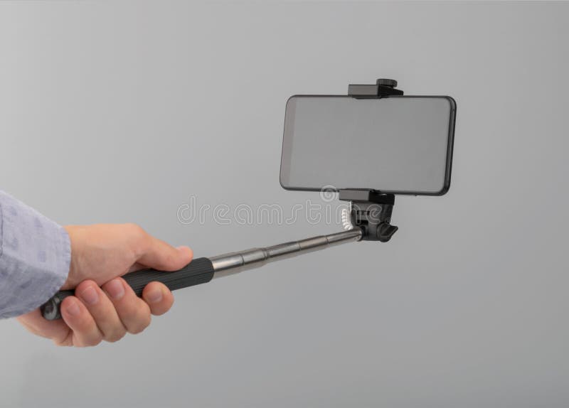 Hand Holds Selfie Stick with Phone with Screen Clipping Path Stock ...