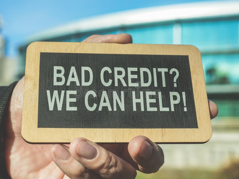 A Hand Holds a Sign Bad Credit, we Can Help. Stock Image - Image of ...