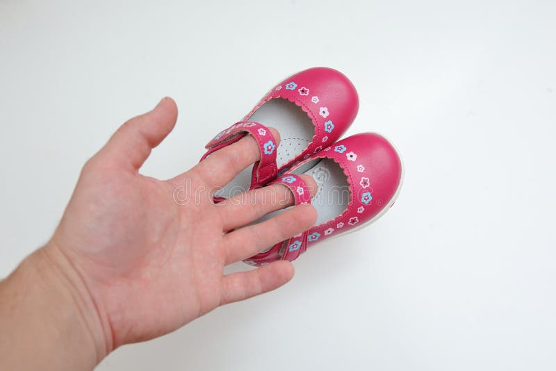 Hand Holds Small Baby Shoes on White Background Stock Photo - Image of ...