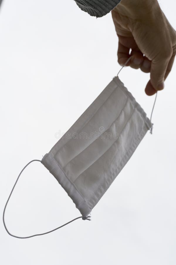 Hand Holds a Surgical Mask in the Wind Over a Cloud Stock Image - Image ...