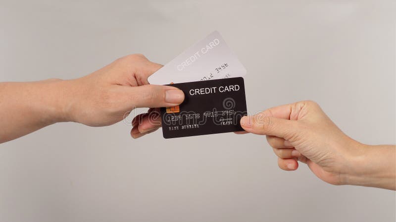 The Hand Holds Two Credit Card and Another Hand is Choosing on White ...