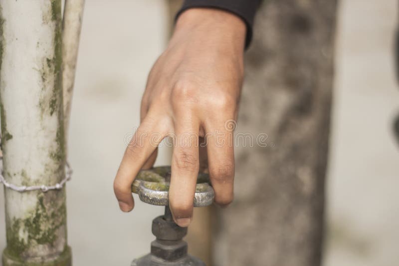 A Hand Holds a Water Lock and the Background is Blurred Stock Photo ...