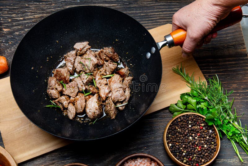 Hand Holds a Wok with Beef Fillet Fried with Argus Vegetables in a Wok ...