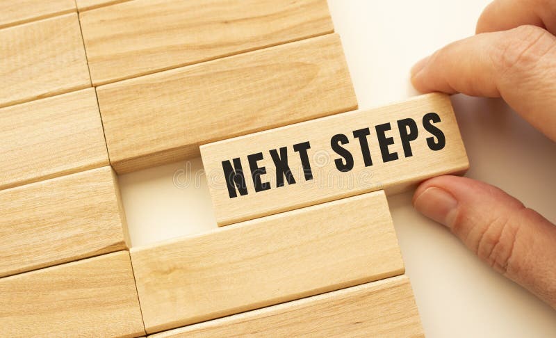 Hand Holds a Wooden Cube with the Text NEXT STEPS Stock Photo - Image ...
