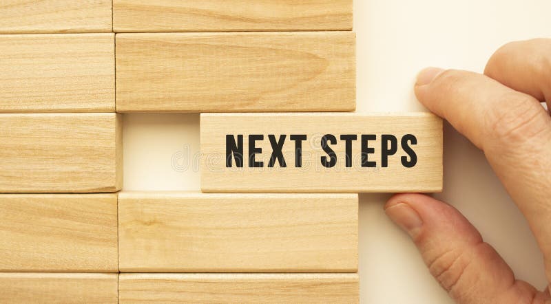 Hand Holds a Wooden Cube with the Text NEXT STEPS Stock Photo - Image ...