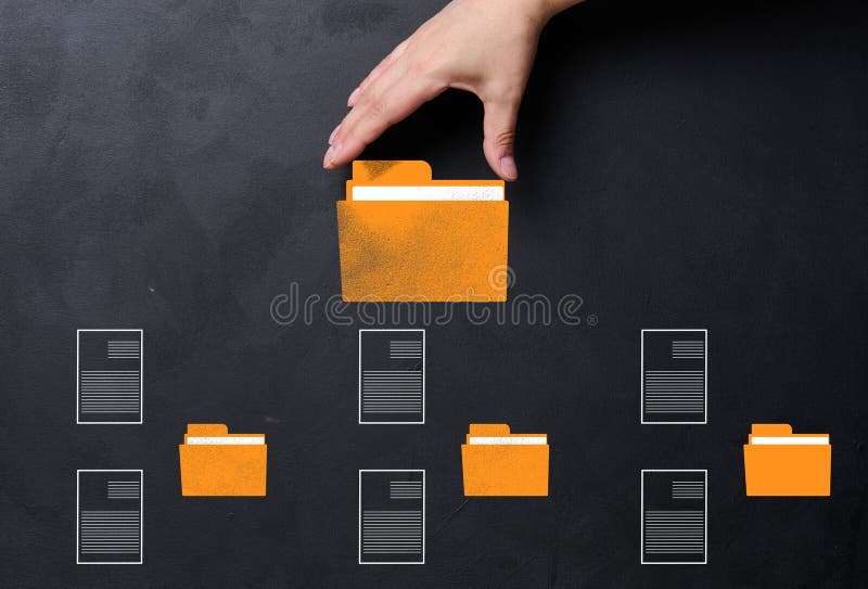 A Hand Holds a Yellow Folder Over a Black Background with Several ...