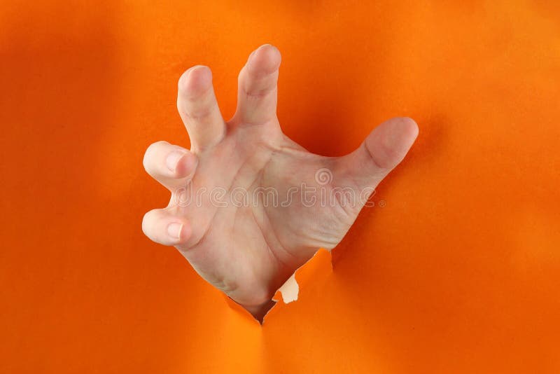 Hand through a Hole in an Orange Cardboard Stock Image - Image of hand ...
