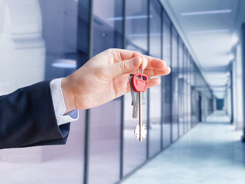 Hand with House Key Against Abstract Modern Office Building Background ...