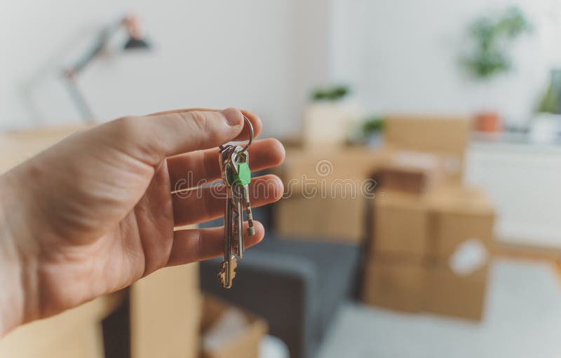 Hand with house key. stock photo. Image of pack, moving - 214092976