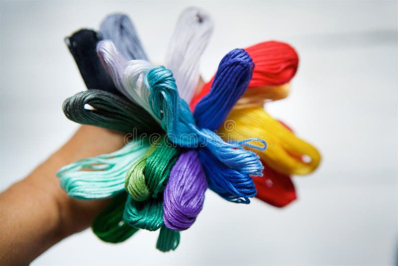 In the Hand of Human Threads of Different Colors and Shades for ...