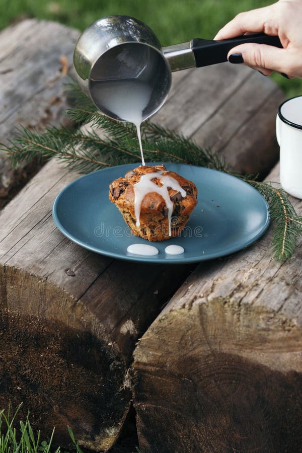 Hand Icing a Muffin Outdoors. Stock Image - Image of crockery, baked ...