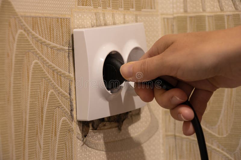 The Hand Includes a Plug in an Old Broken Socket in the Hallway of the ...