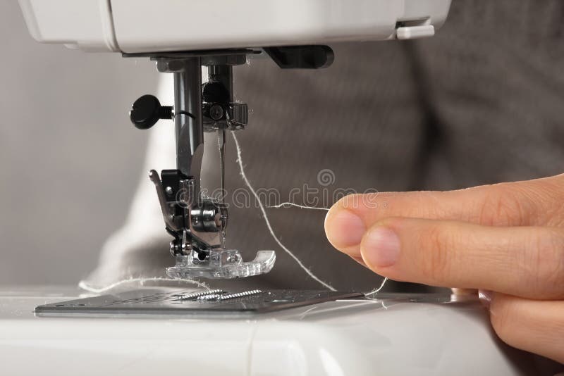 Hand Insert a Thread into the Needle of Sewing Machine Stock Photo ...