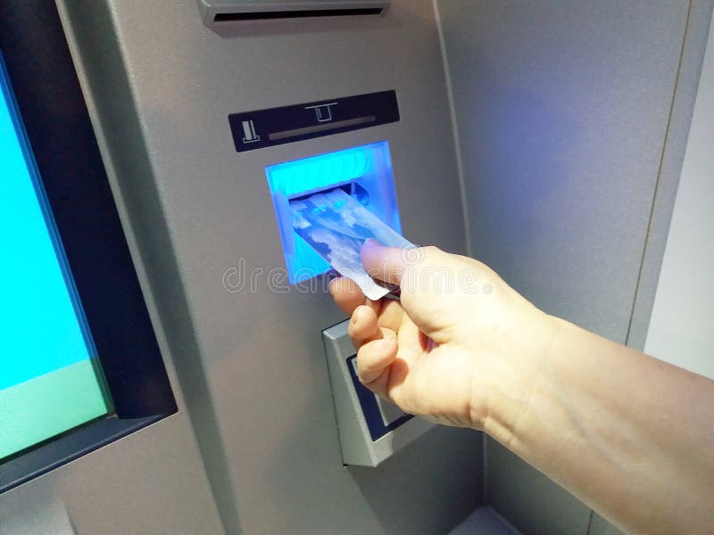 Hand Inserting ATM Card into Bank Machine To Withdraw Money Stock Photo ...