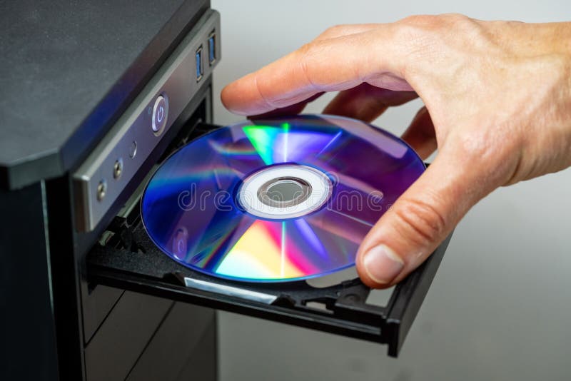 Hand Inserting DVD into a Computer. Closeup. Stock Image - Image of ...