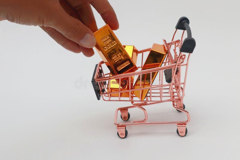 Hand Inserting Gold Bars Next To Shopping Cart Stock Image - Image of ...