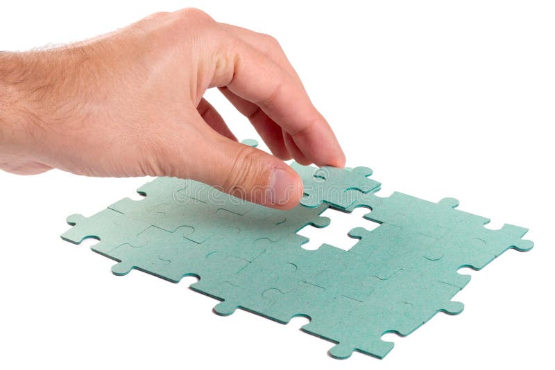 Hand Inserting Missing Piece of Jigsaw Puzzle Stock Photo - Image of ...