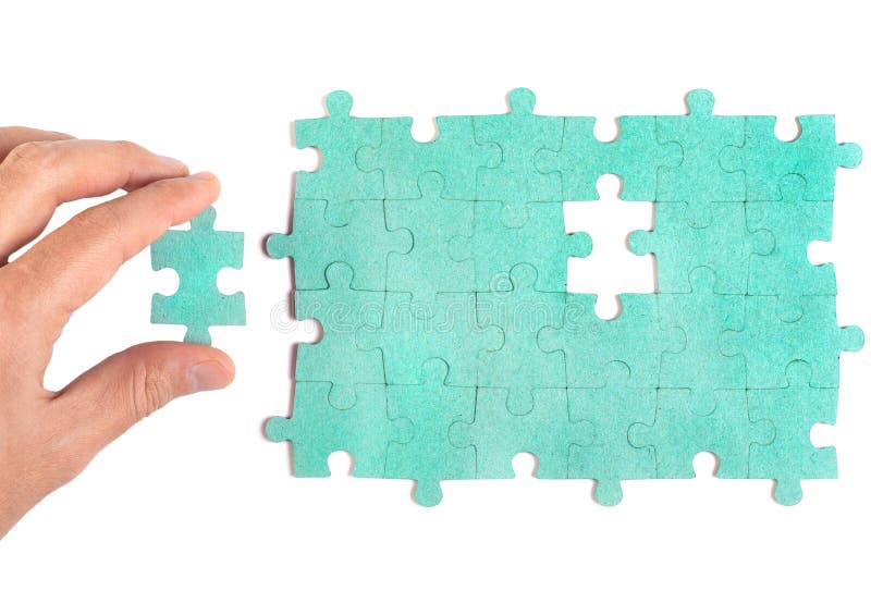 Hand Inserting Missing Piece of Jigsaw Puzzle Stock Photo - Image of ...