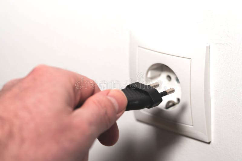 Hand Inserting Power Cord Plug into Wall Outlet Stock Image - Image of ...