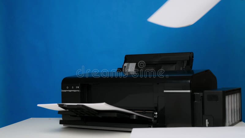 A Hand Inserts Blank Sheets of A4 Paper into the Printer on a Blue ...